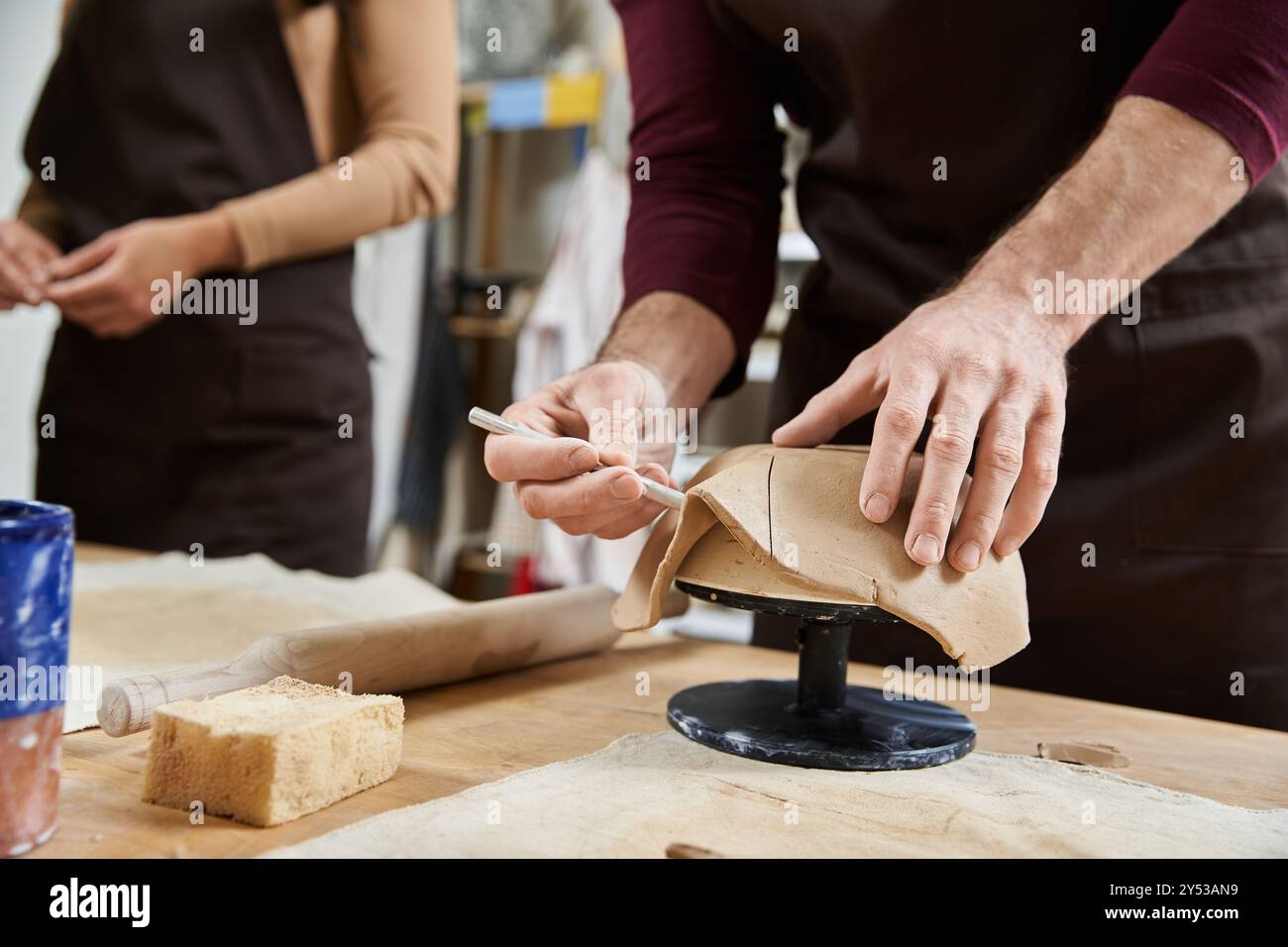 A couple shares a joyful moment shaping clay together Stock Photo - Alamy
