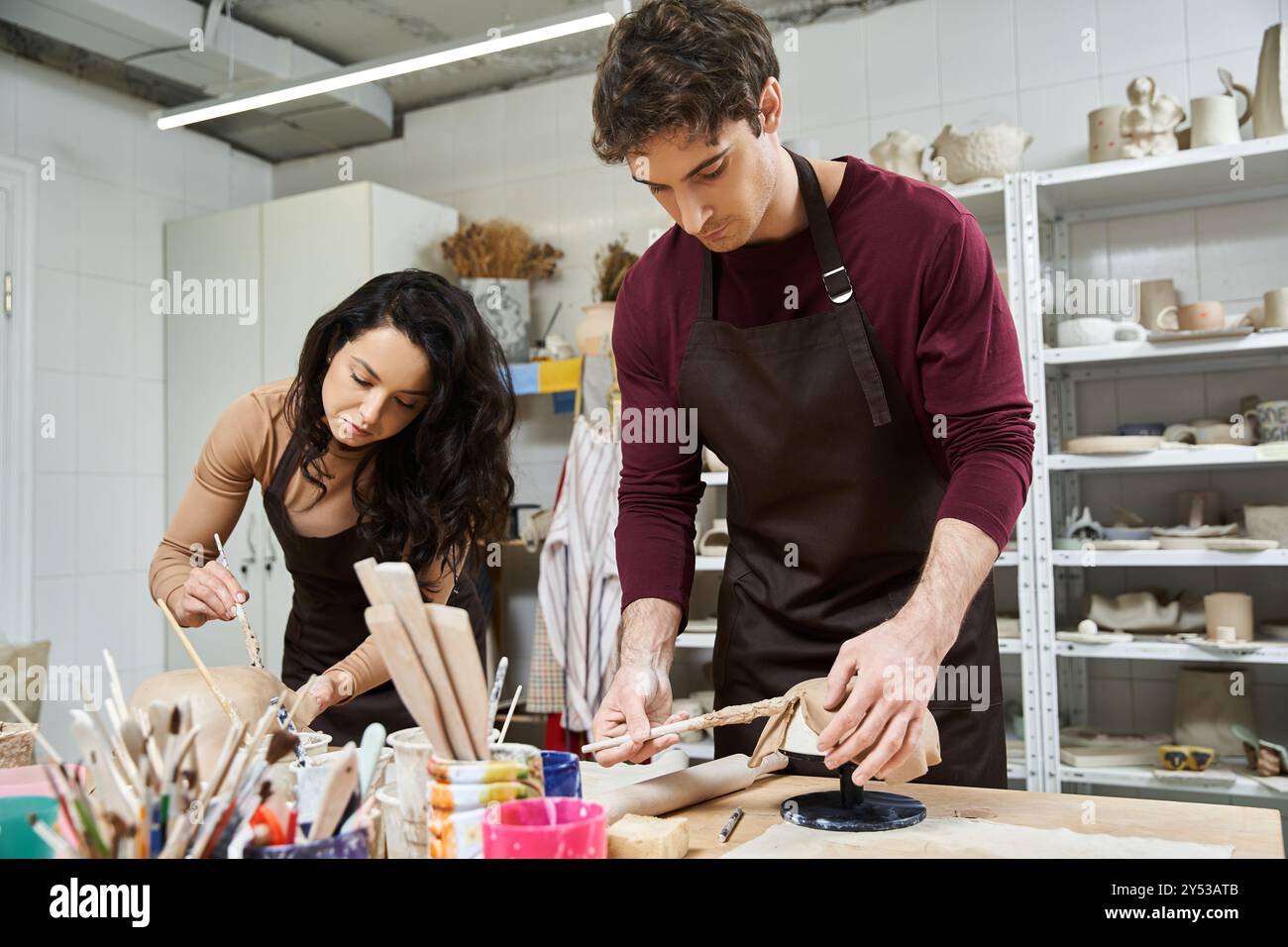 Two artists share a moment making pottery together in a contemporary ...