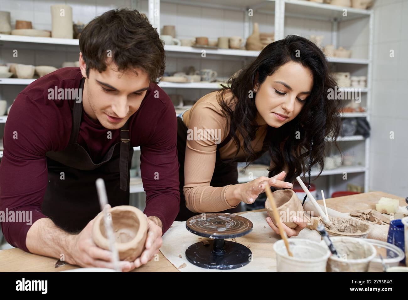 A couple joyfully crafts pottery side by side in a contemporary ...