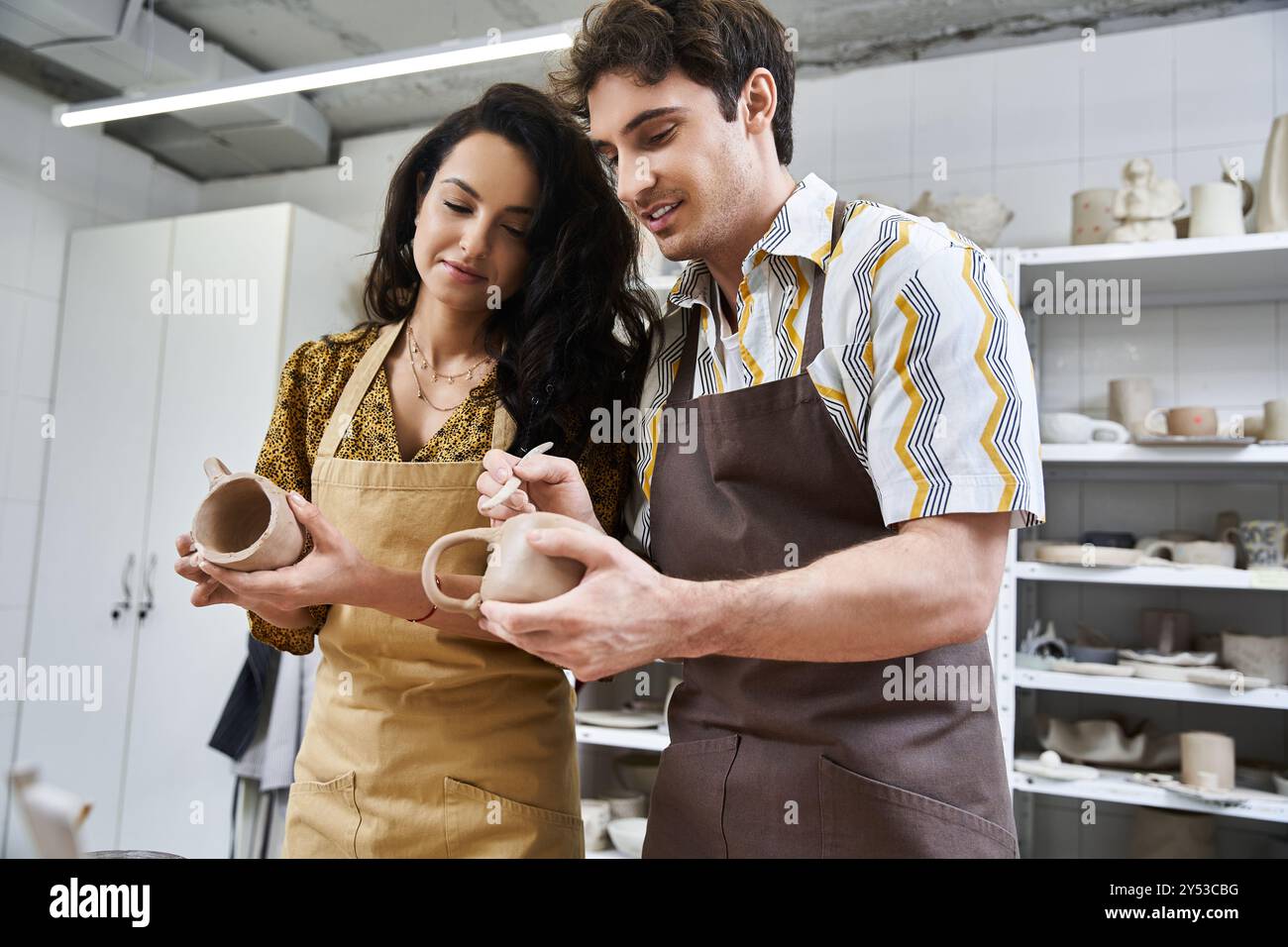 A couple joyfully shapes pottery together, surrounded by artistic tools ...