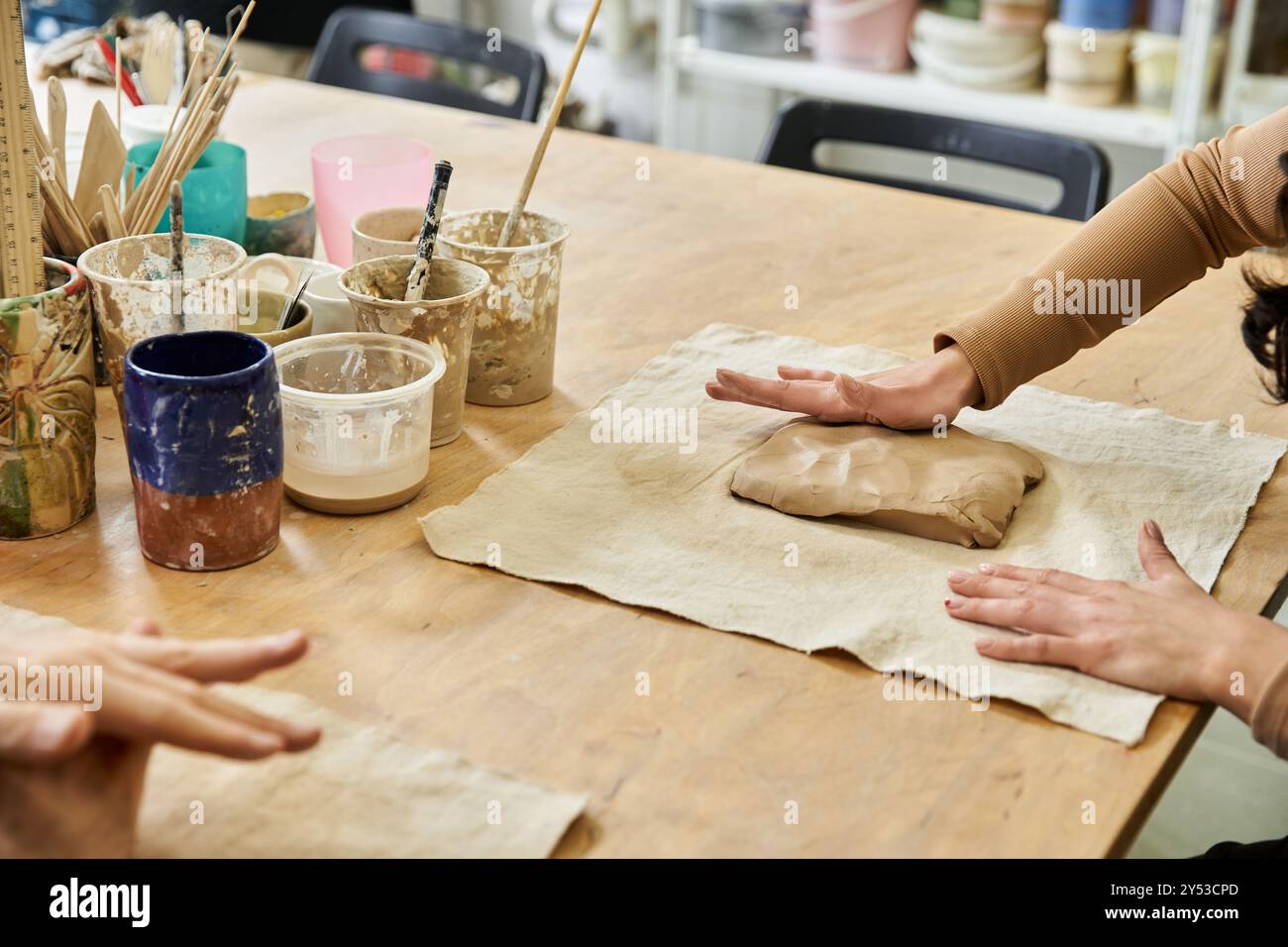 A couple enjoys creating pottery together in a vibrant studio setting ...