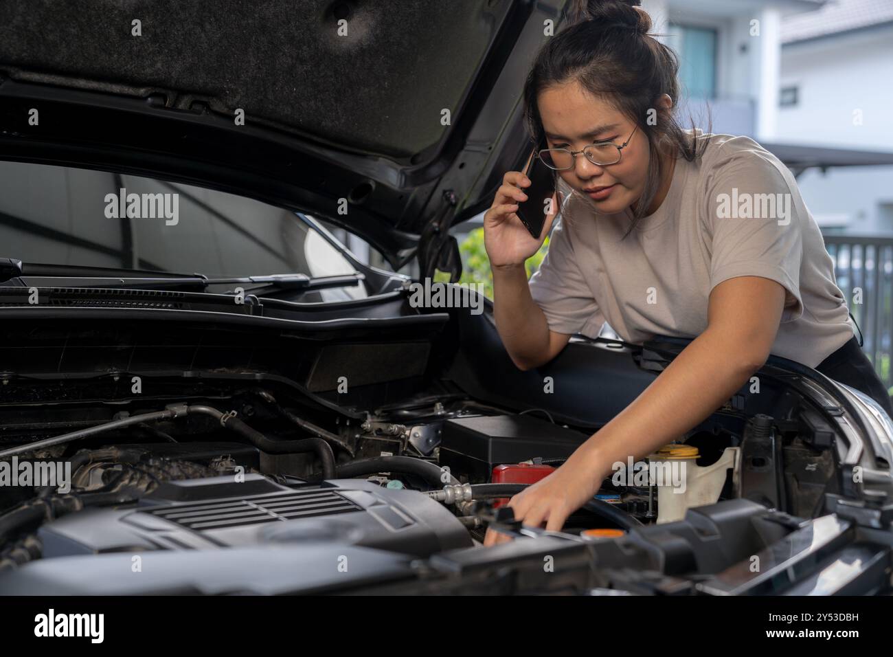 The woman is experiencing a car breakdown and is calling for assistance ...