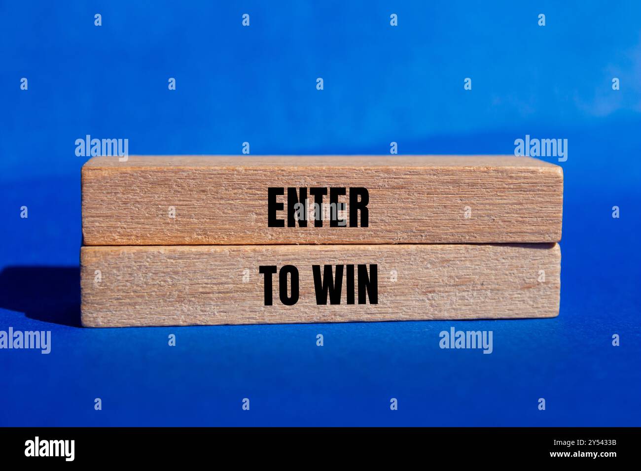 Enter to win message written on wooden blocks with blue background ...