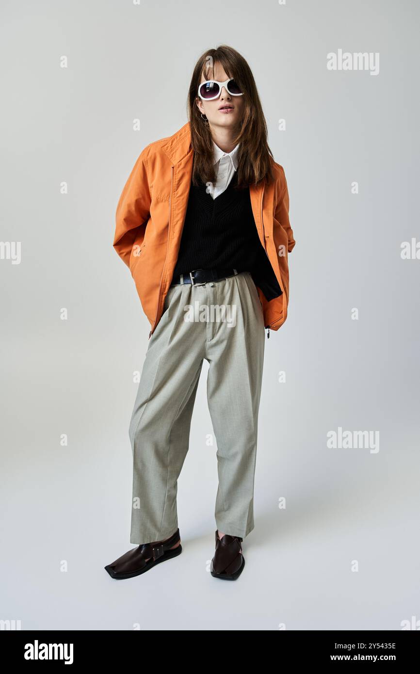 A fashionable young person showcases a trendy outfit with an air of ...