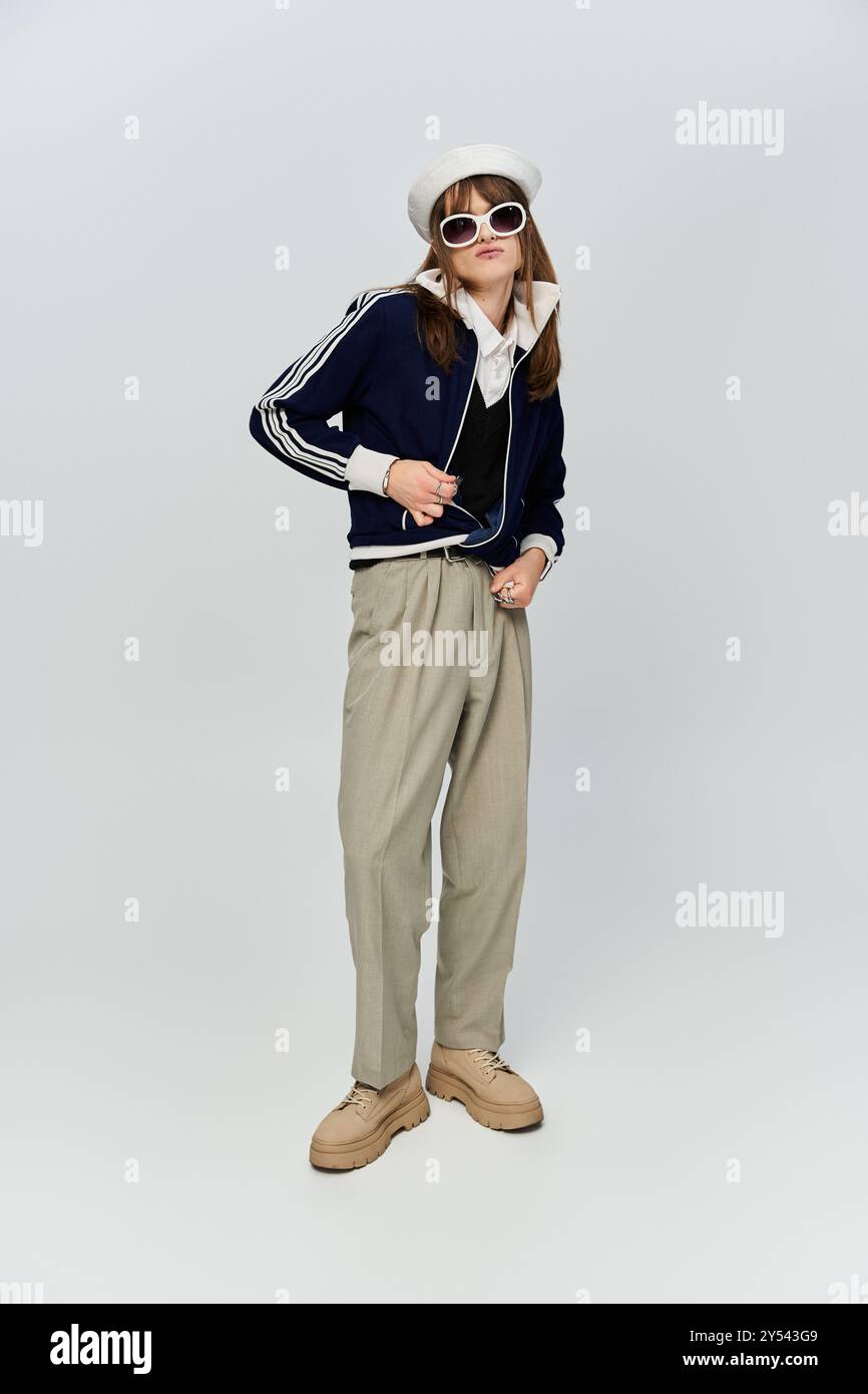 Dressed in trendy attire, the young man poses confidently against a ...