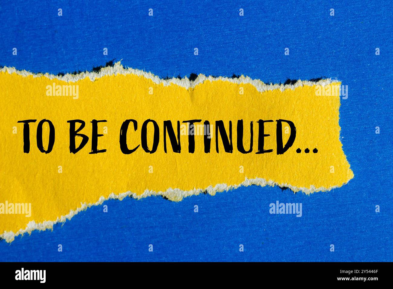 To be continued message written on ripped torn yellow paper with blue ...