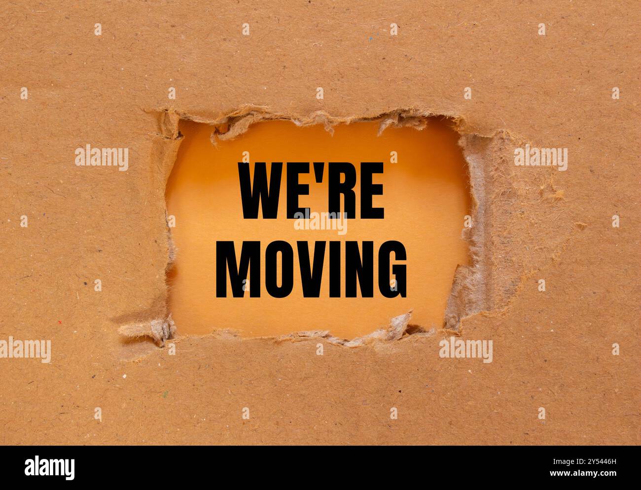 We are moving message written on ripped torn cardboard paper with ...