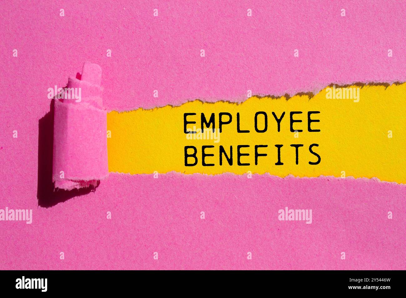 Employee benefits message written on ripped torn pink paper with yellow background. Conceptual ...