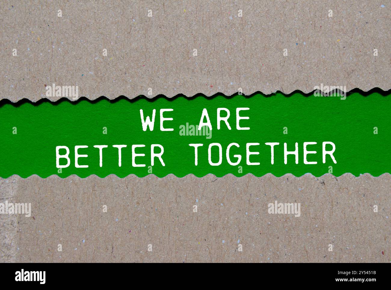 We are better together message written on ripped torn paper on green ...