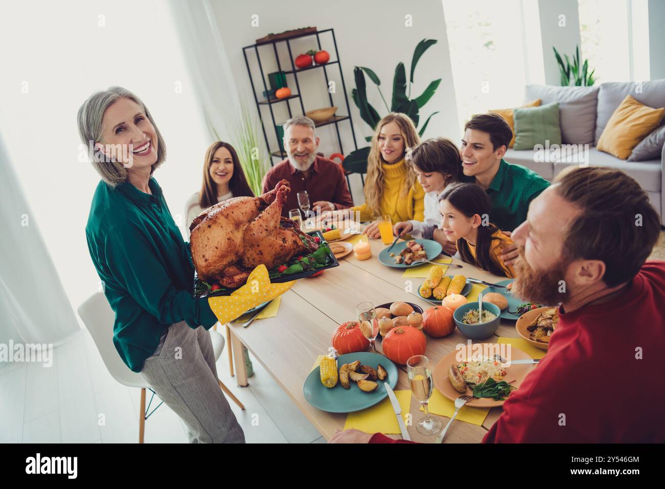 Photo of positive big family celebrating thanksgiving day together cozy ...