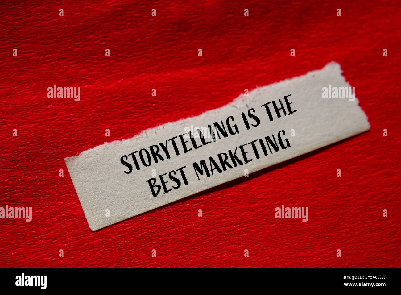 Storytelling is the best marketing message written on torn paper with ...