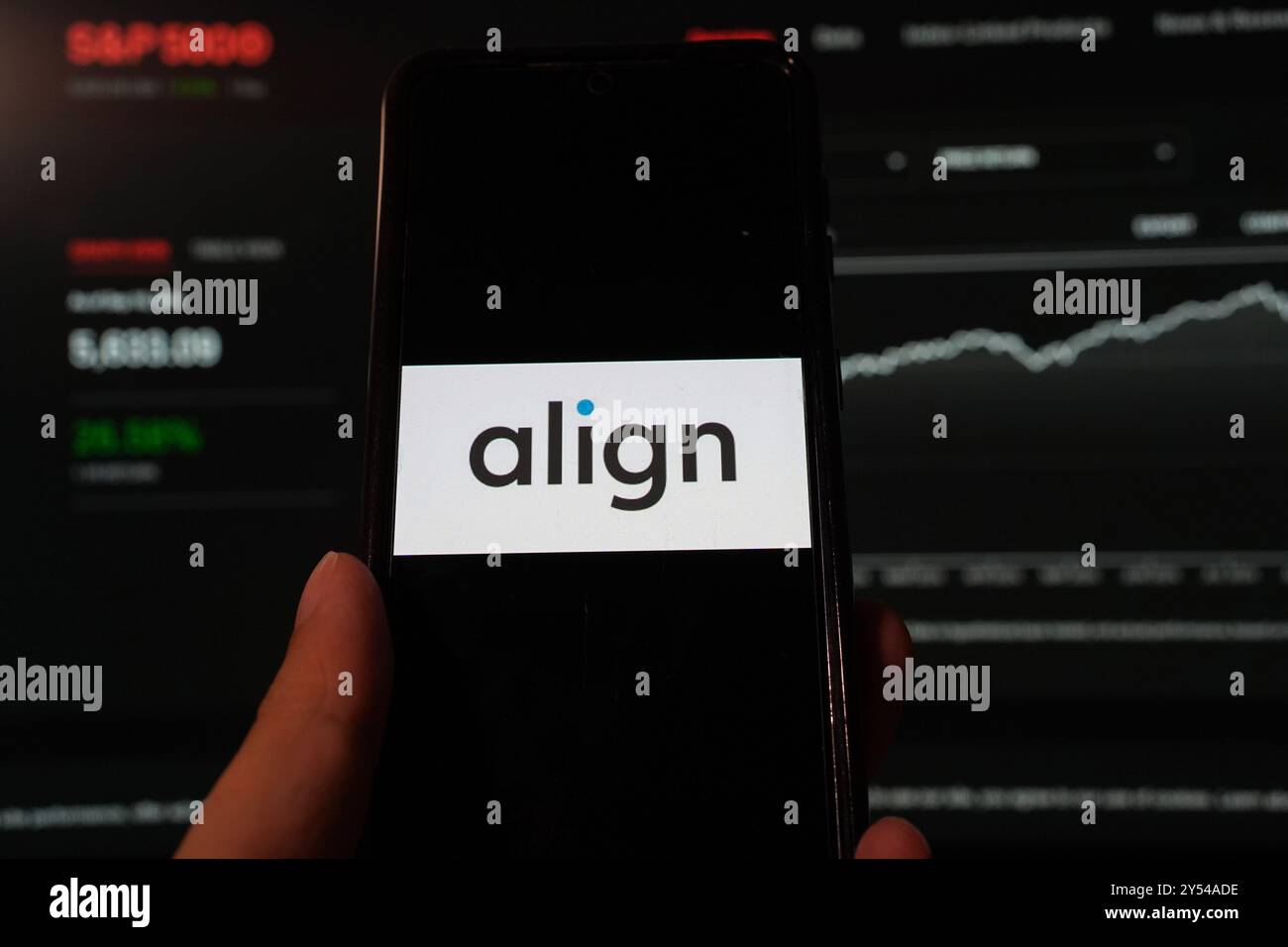 In this photo illustration, Align Technology logo is displayed on a smartphone with a S&P index ...