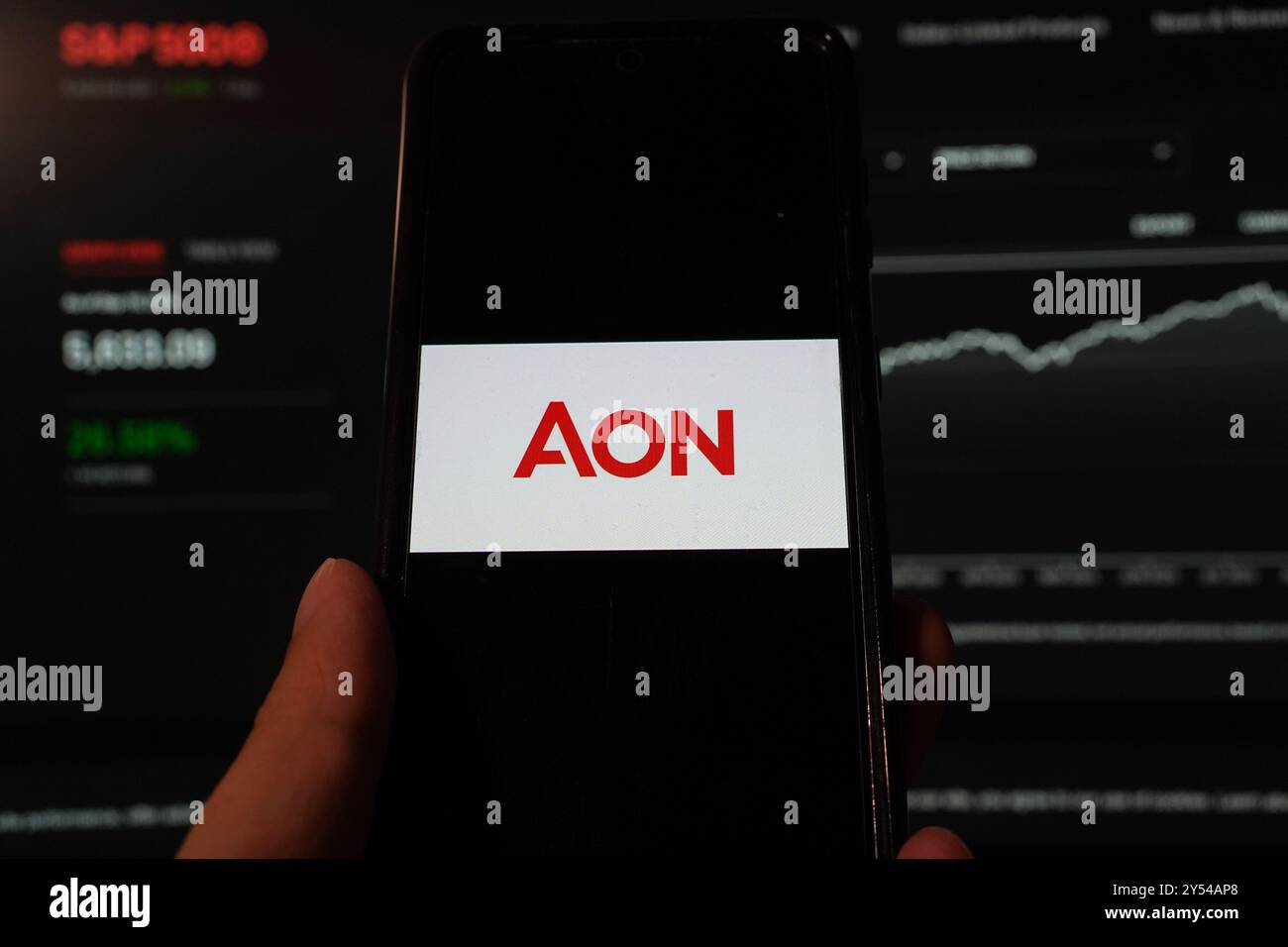 In this photo illustration, Aon logo is displayed on a smartphone with ...