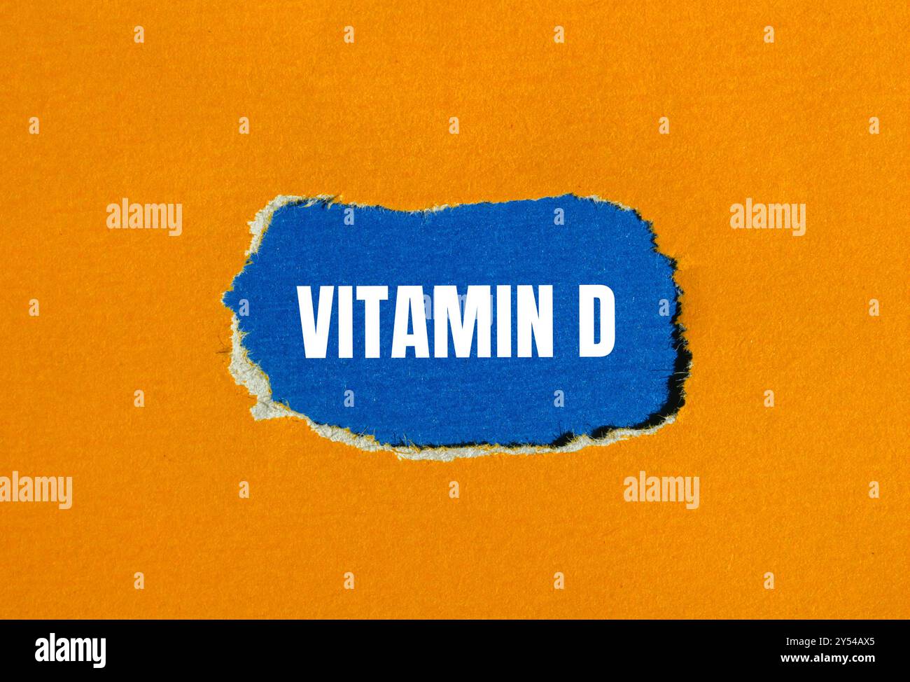 Vitamin d message written on ripped torn orange paper with blue ...