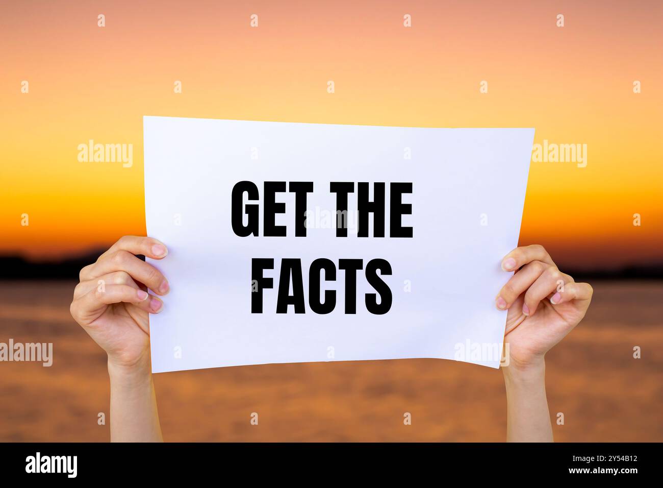 Get the facts message written on white paper with blurry lake ...
