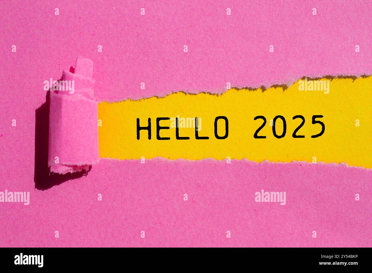 Hello 2025 message written on ripped torn pink paper with yellow ...