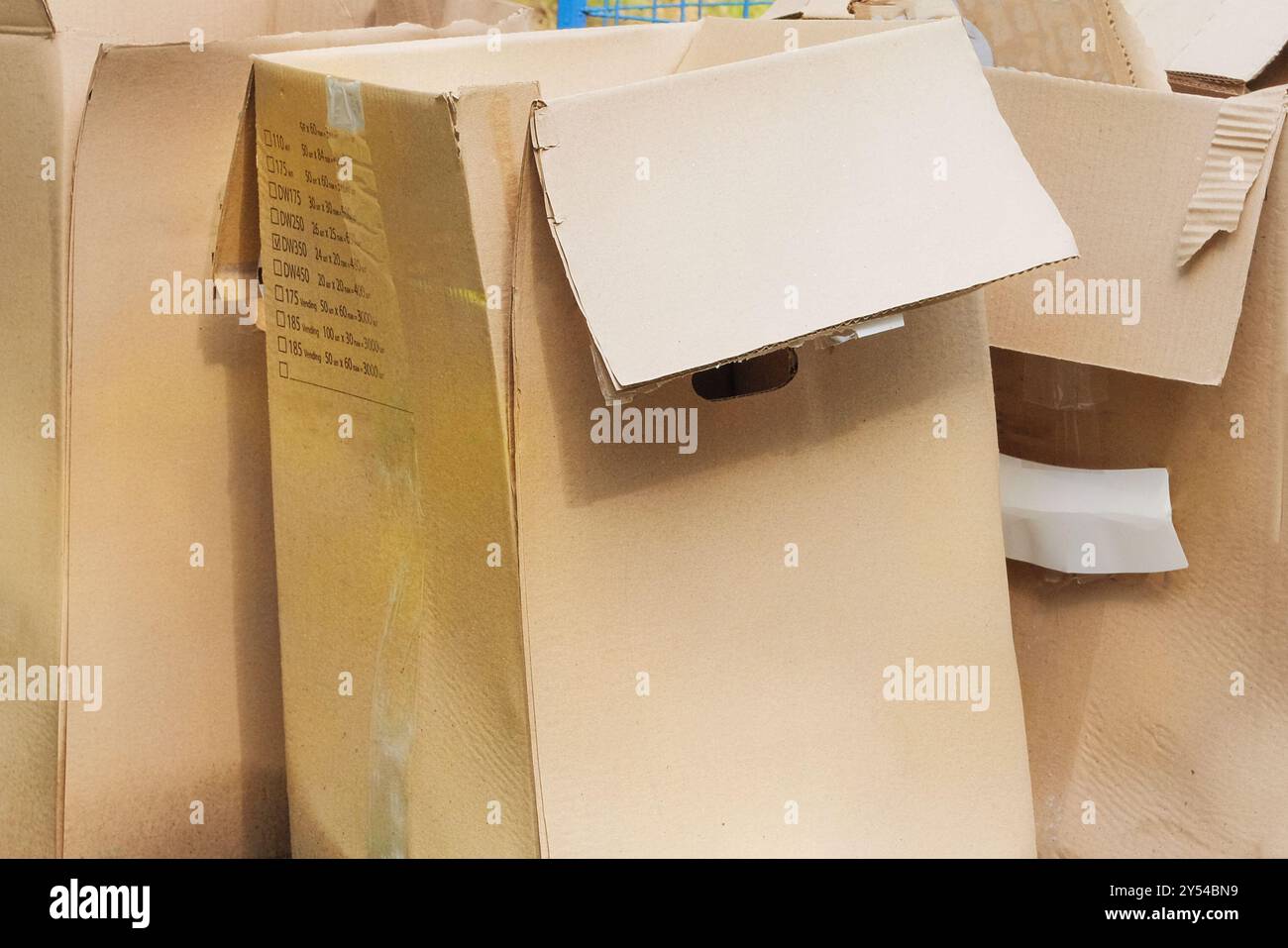 Cardboard and waste paper is packaged for recycling. Garbage stacked ...