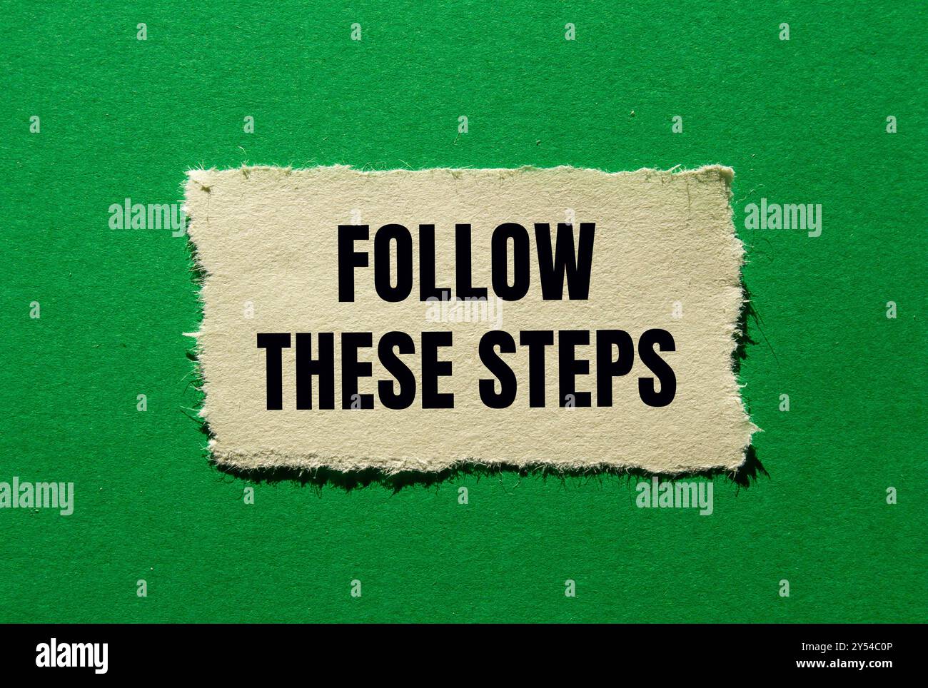 Follow these steps message written on ripped torn paper piece on green ...