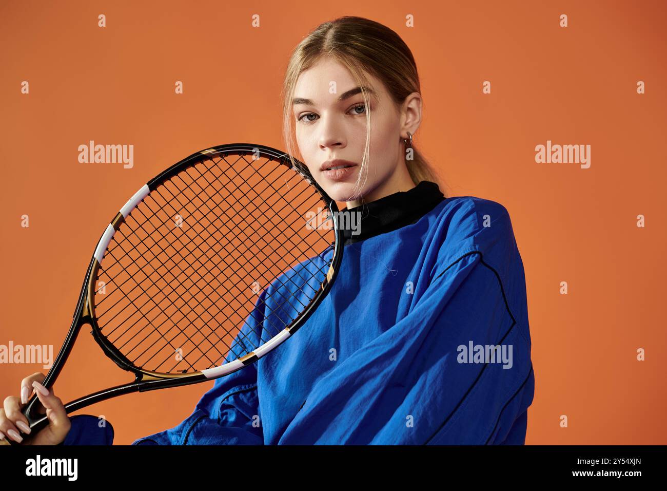 A talented athlete expresses her emotions while holding a tennis racket ...
