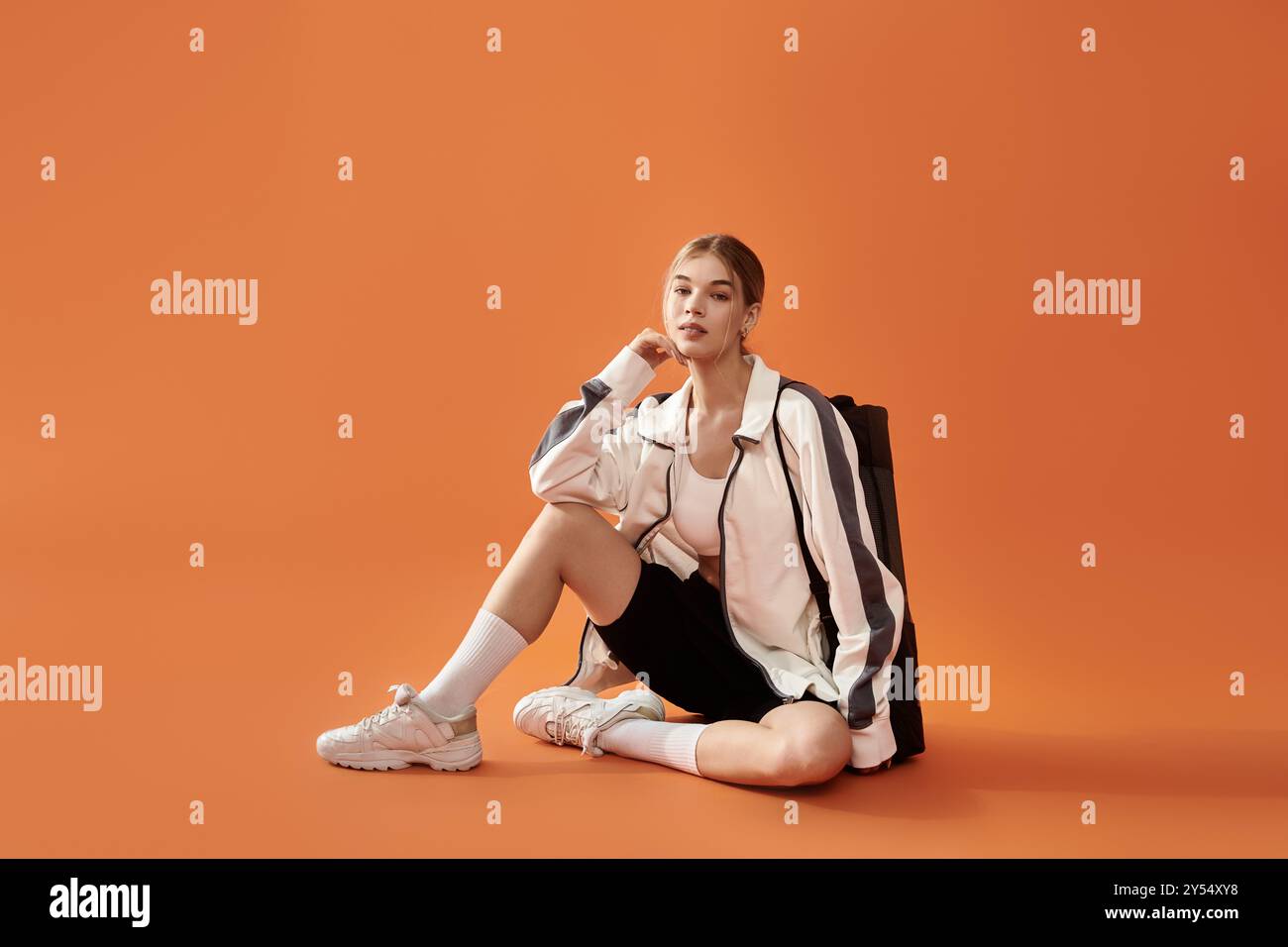 A talented athlete poses thoughtfully, showcasing her strength and ...