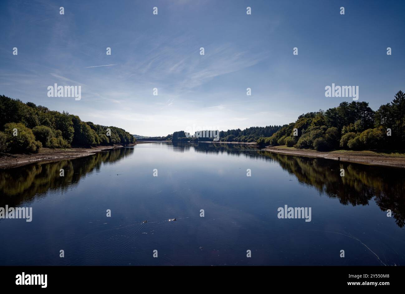 The starkly blue water and sky of late summer at Wayoh Reservoir in the ...