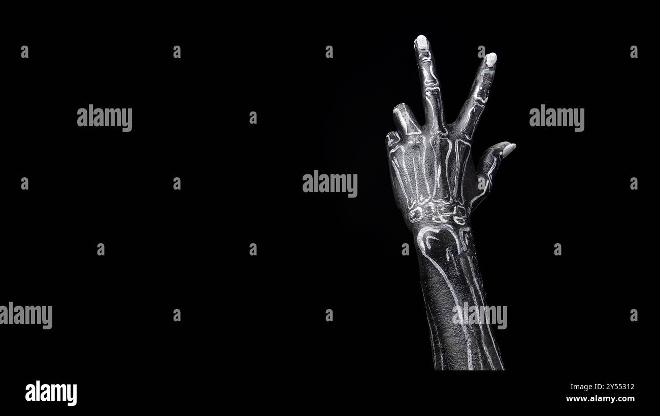Human hand painted as skeleton gesturing against black background ...