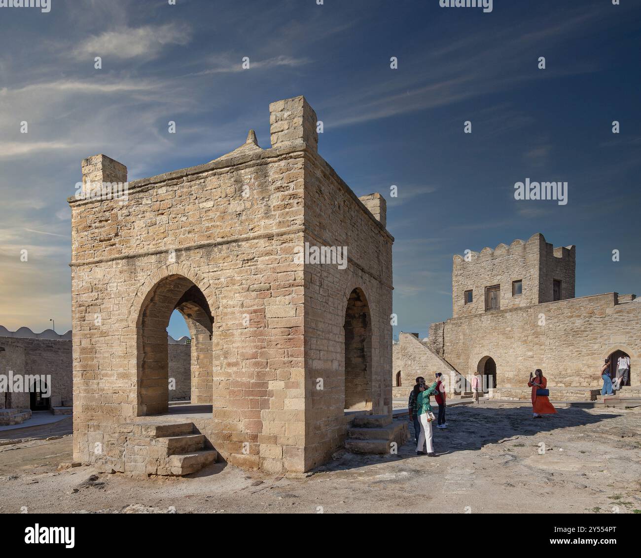 Baku, Azerbaijan - May 9, 2024: Tourists stand in the courtyard of the ...