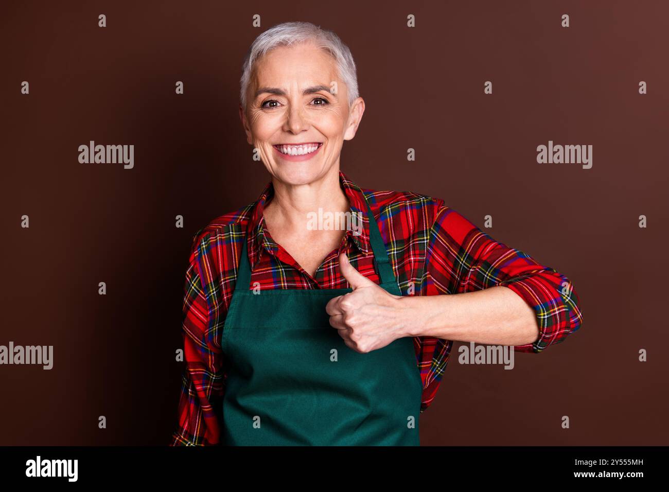 Photo of lovely senior cheerful lady wear red plaid shirt thumb up ...