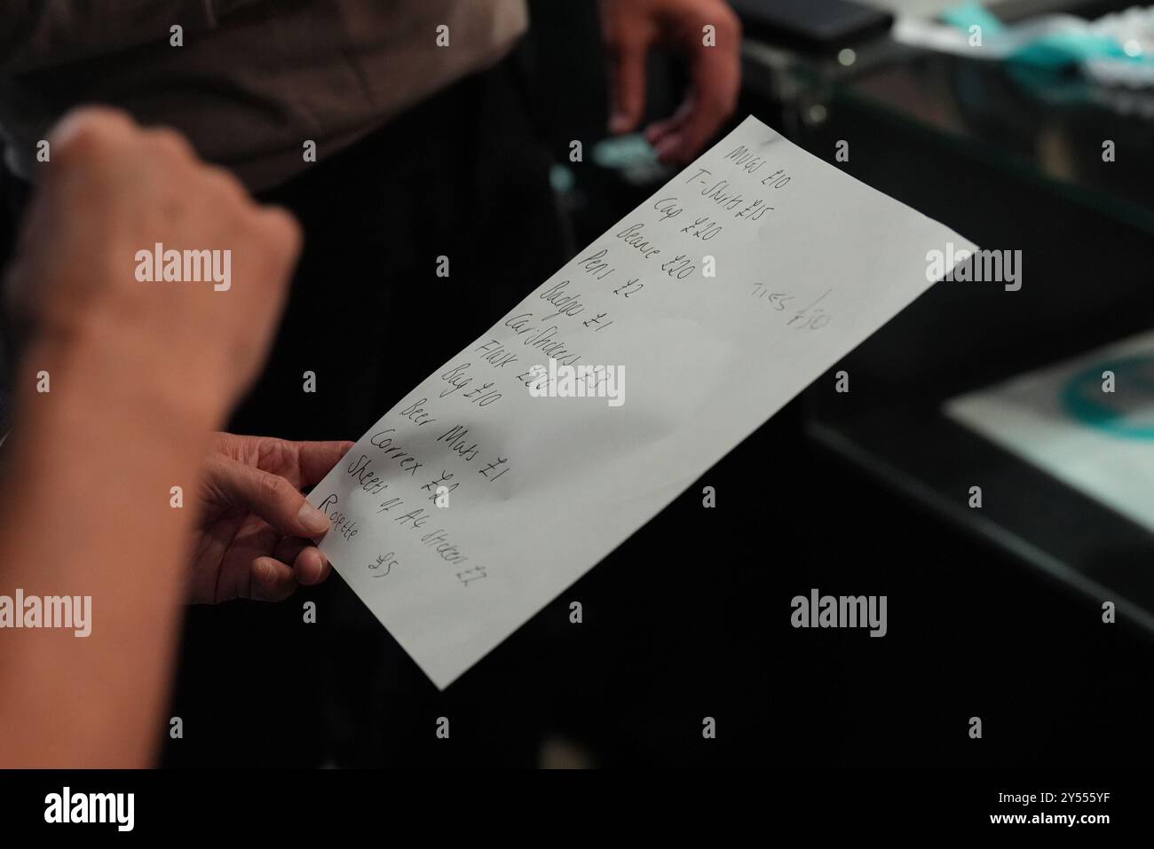 A hand written price list for Reform UK merchandise on sale at the ...