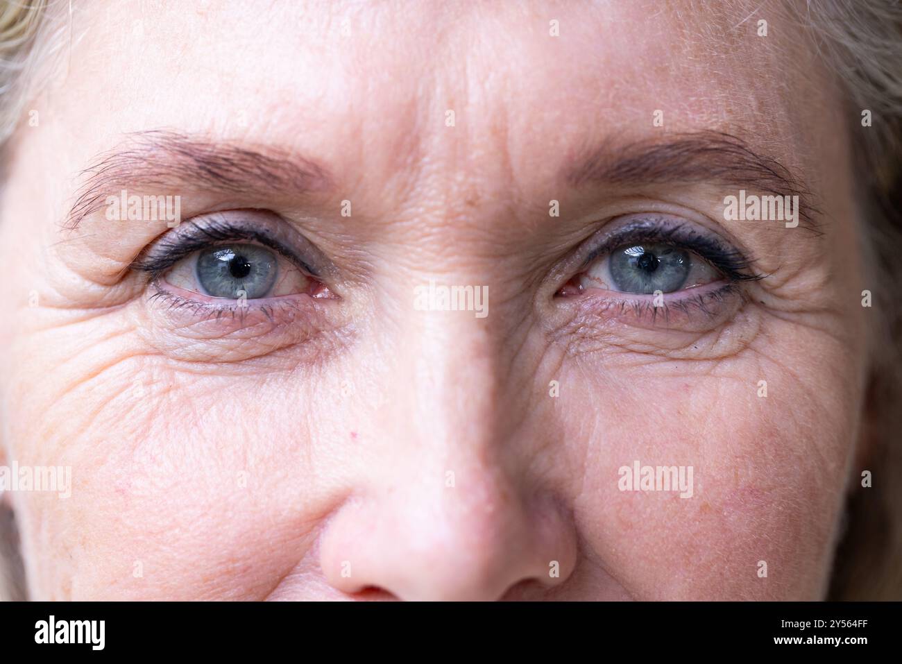 At home, Close-up of senior woman's eyes, showing wrinkles and aging ...