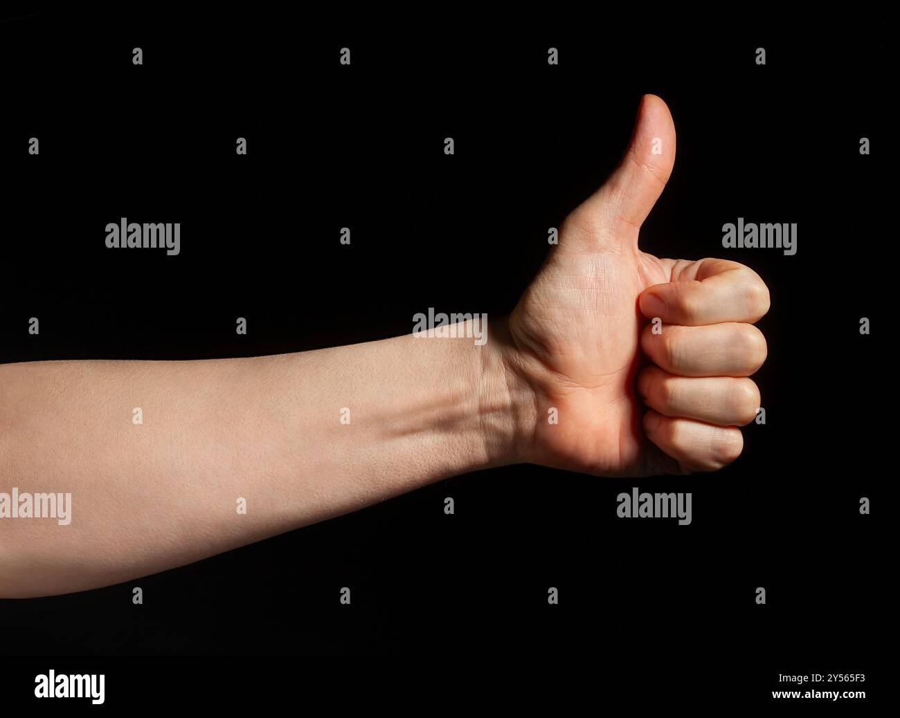 thumbs up hand gesture on black background Stock Photo - Alamy