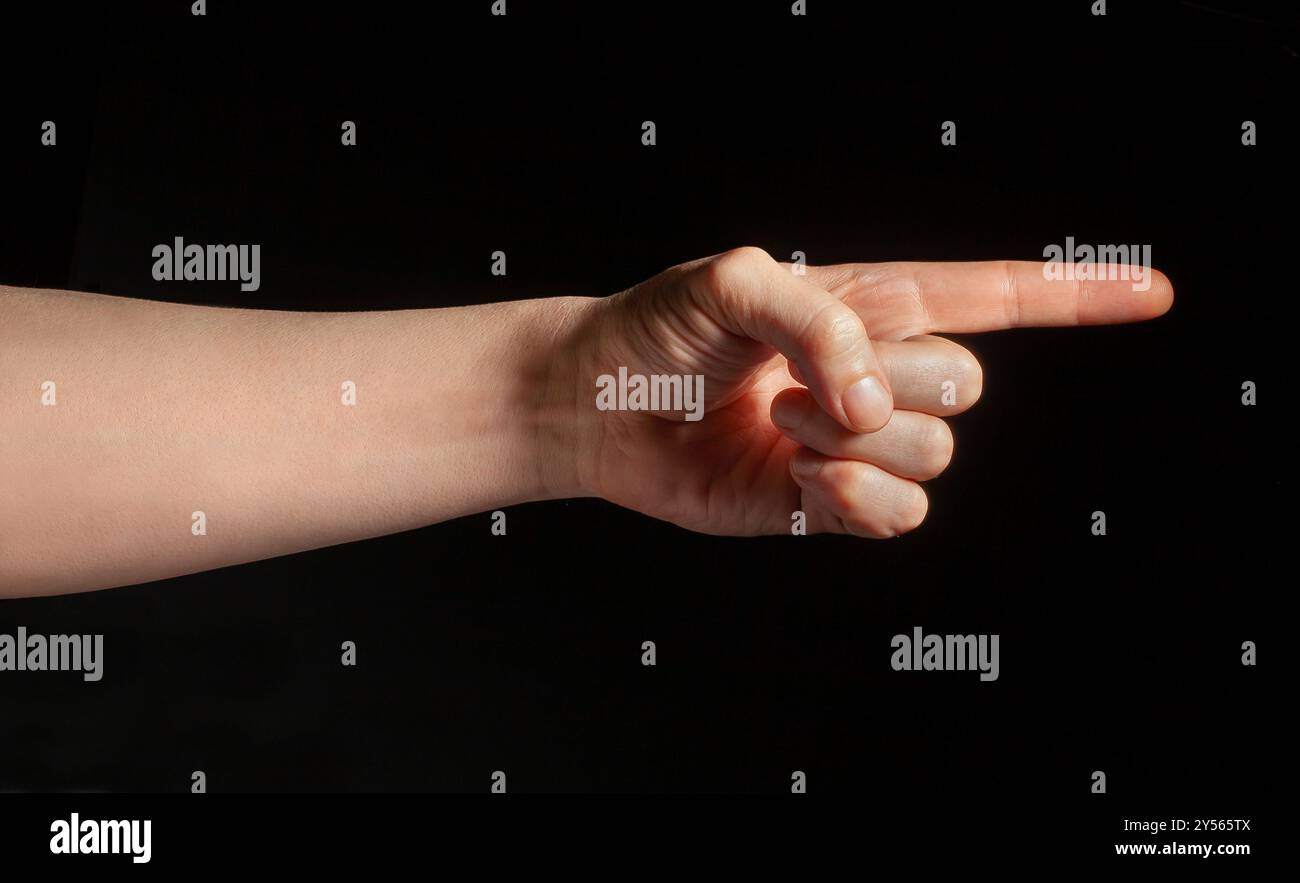 pointed index finger hand gesture on black background Stock Photo - Alamy