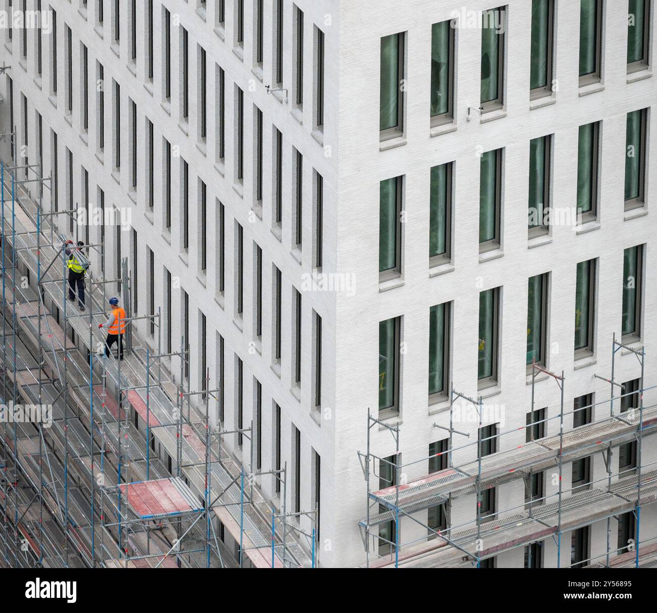 Construction worker remove scaffolding of a new building Stock Photo ...