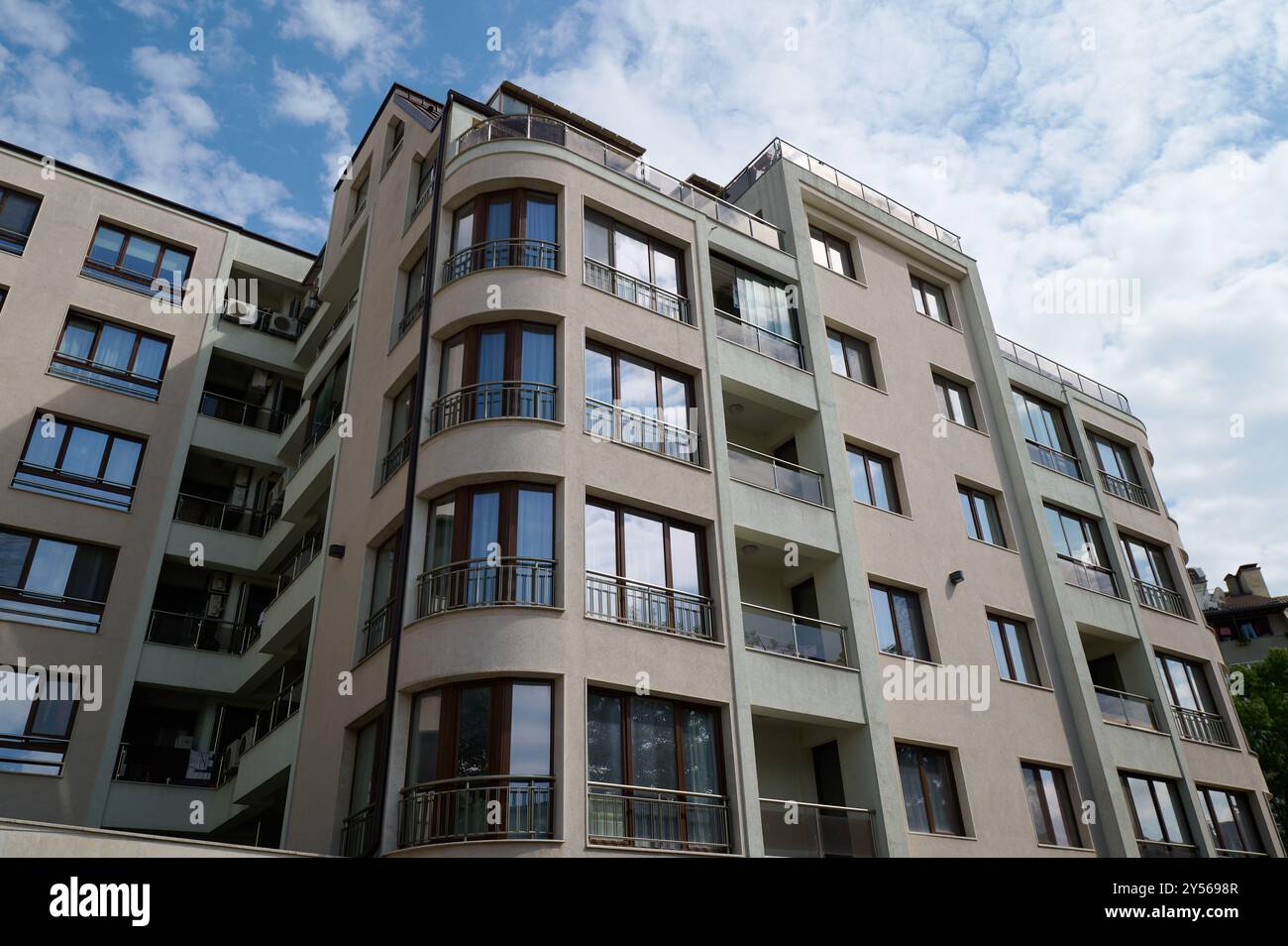 Modern residential building showcasing curved balcony design in a ...