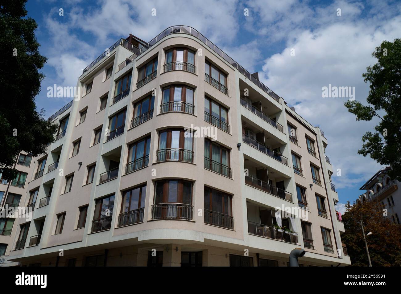 Modern apartment building showcasing curved architecture in an urban ...