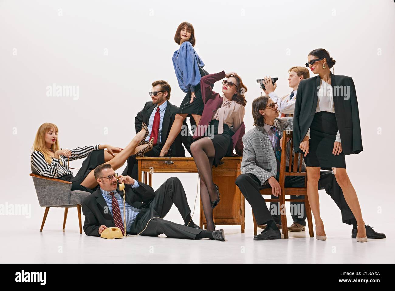 Office moment, where group playfully gathers around desk, showing more ...