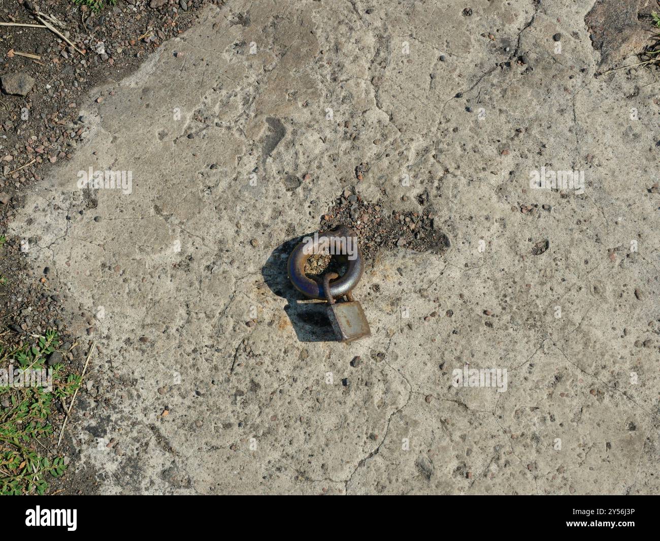 an old ground anchor embedded in a stone surface. It was used for load ...