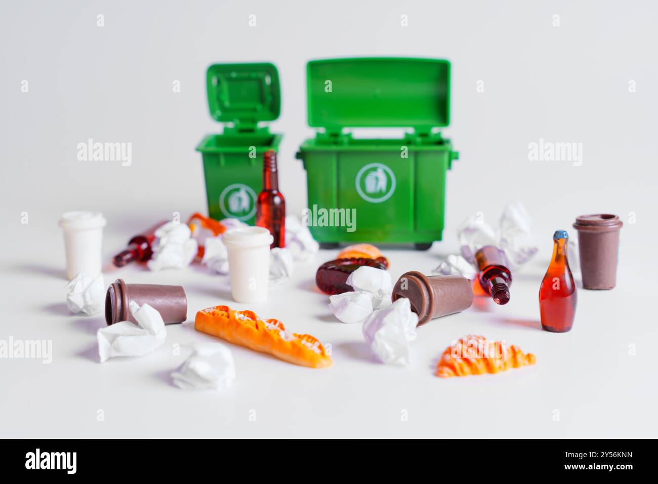 Miniature scene depicting food waste, trash coffee cups, crumpled paper ...