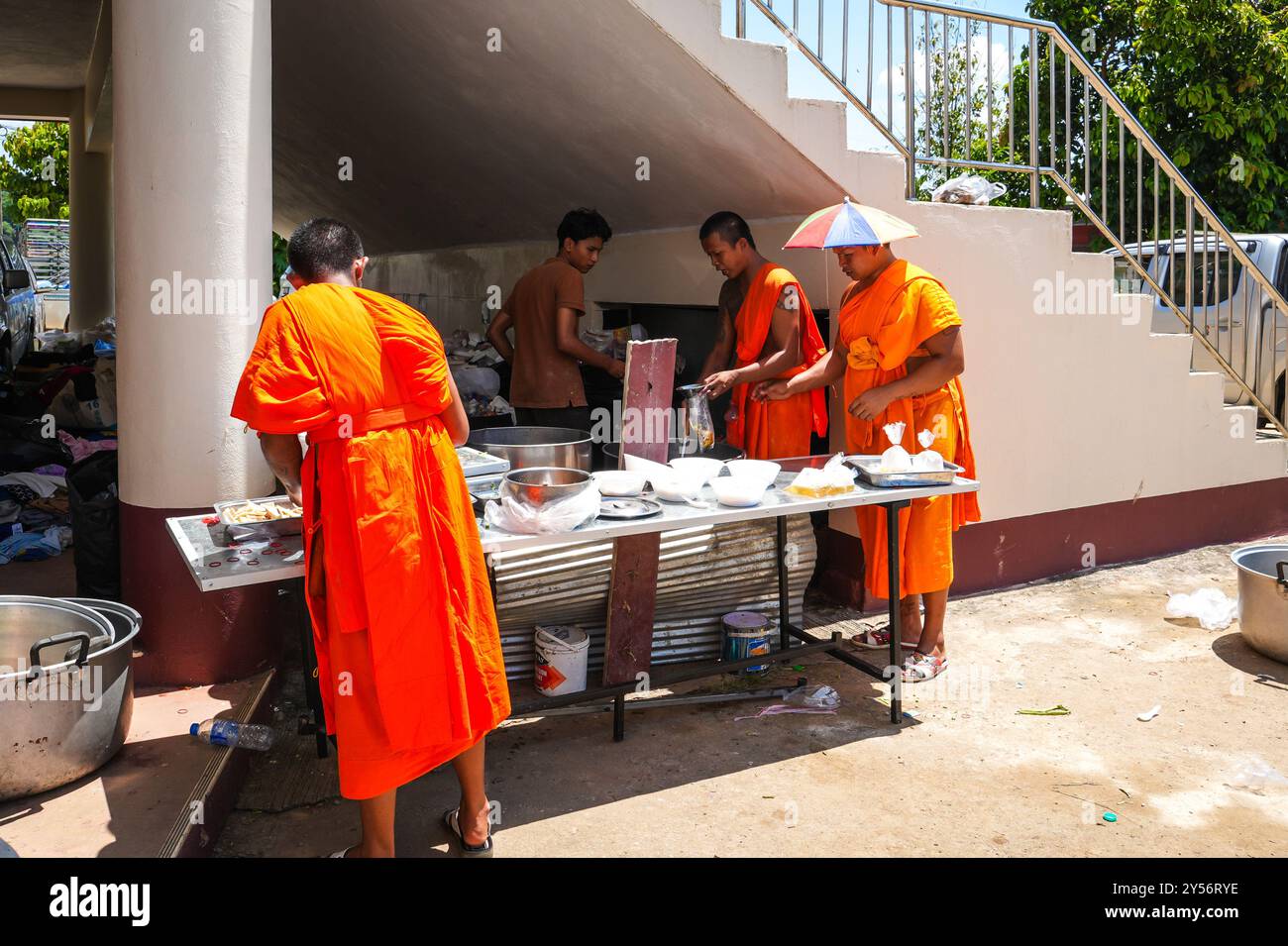 Monks are seen preparing meals for donations, after the flood-ravaged ...