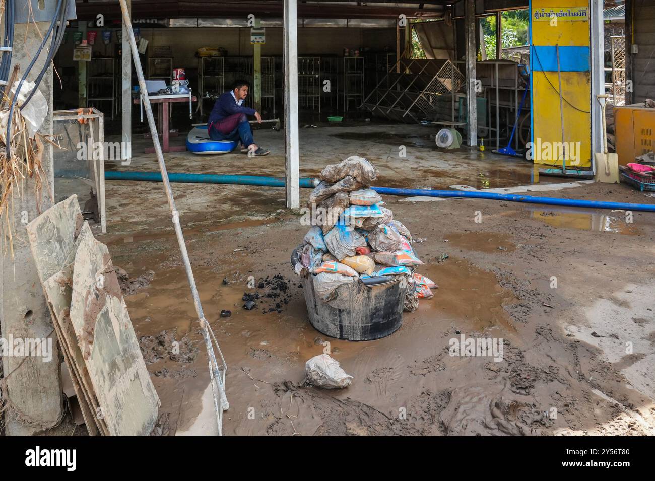 A man is seen sitting desperately in his devastated store, after the ...