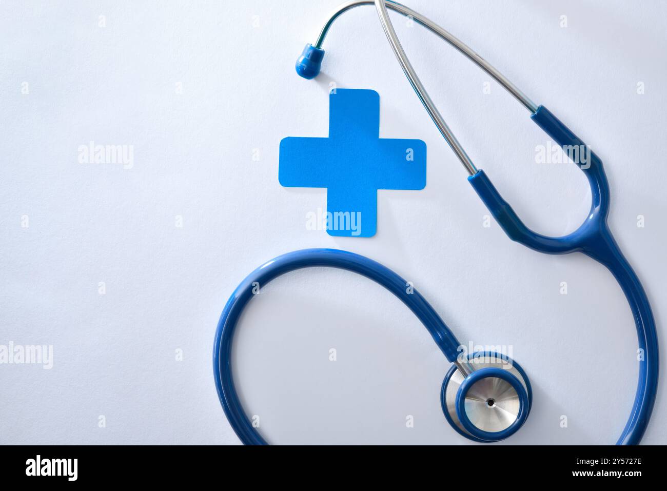 Health background with stethoscope and blue cross isolated on white ...