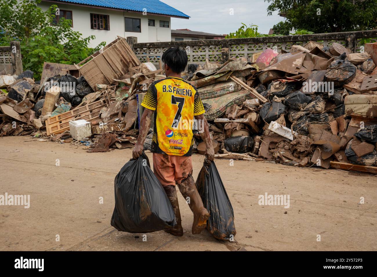 Chiang Rai, Thailand. 18th Sep, 2024. A man is seen carrying garbage ...