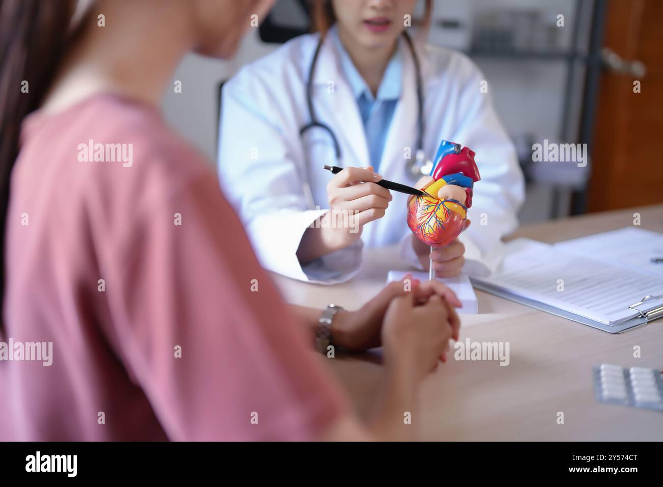 Asian cardiologist doctor women explaining about anatomical of human ...