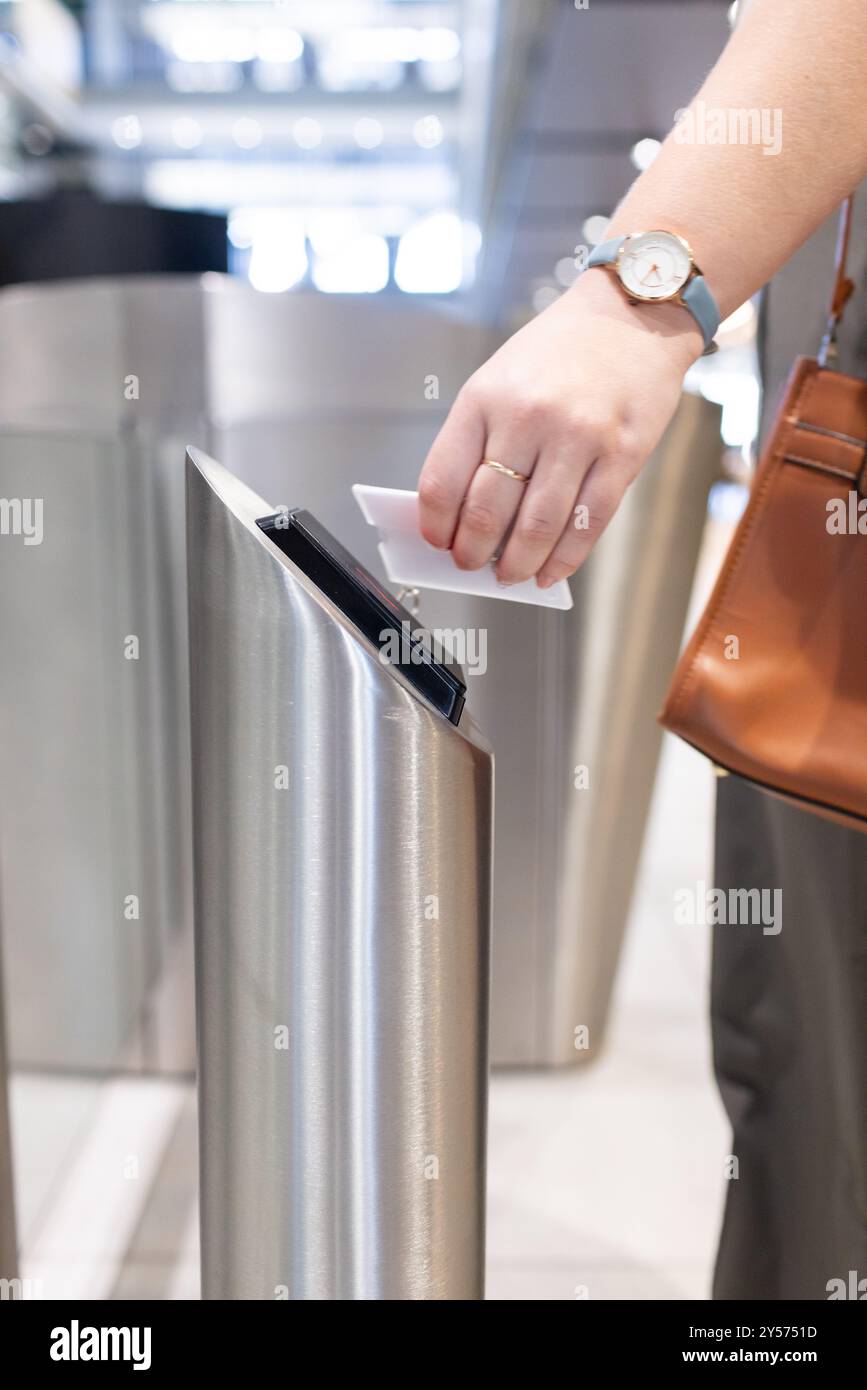 Scanning access card, woman entering office building through security ...