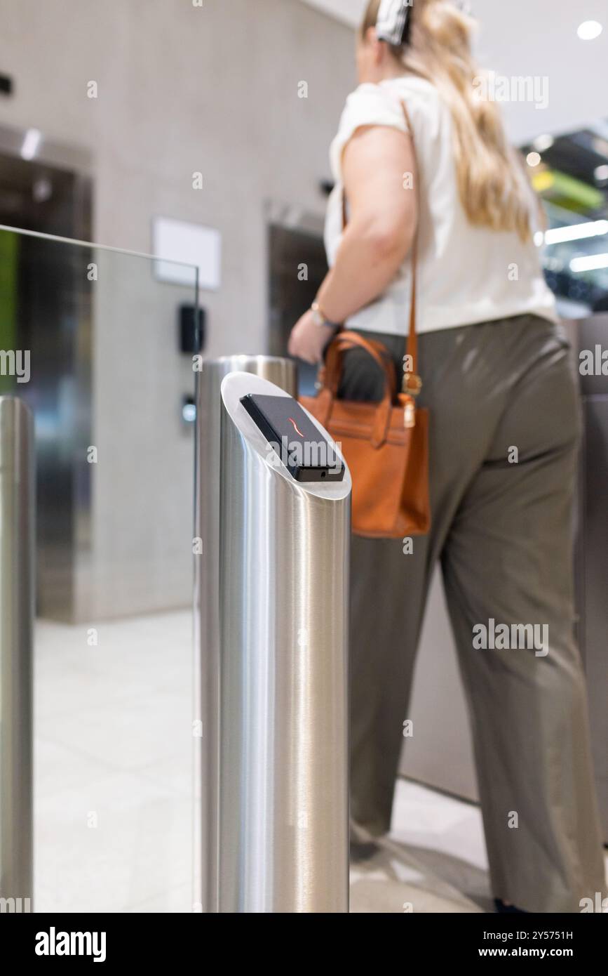 Entering office building, woman with handbag using access card at ...