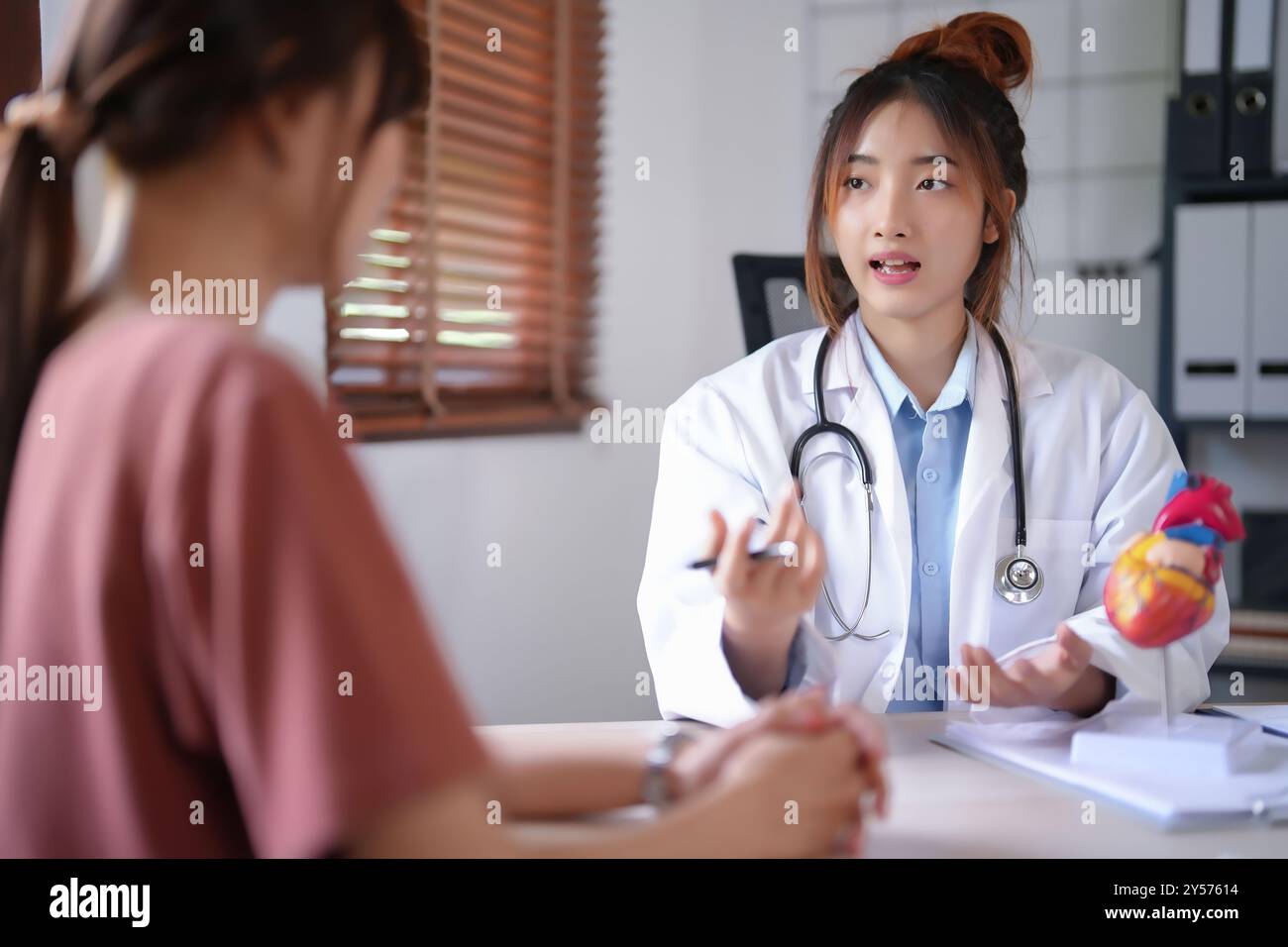 Asian cardiologist doctor women explaining about anatomical of human ...