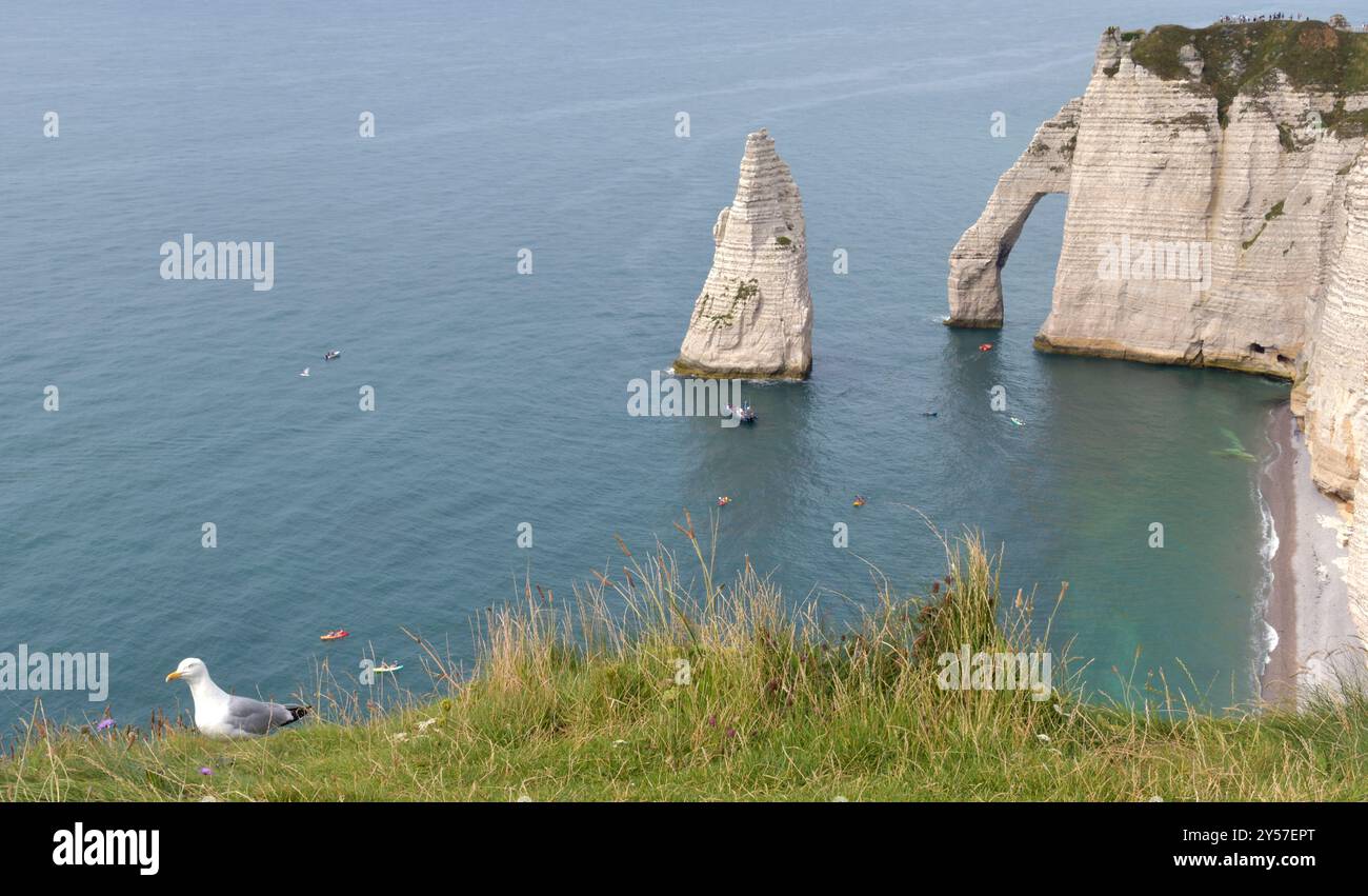 surrounded by the impressive cliffs above and below, Etretat Beach is ...