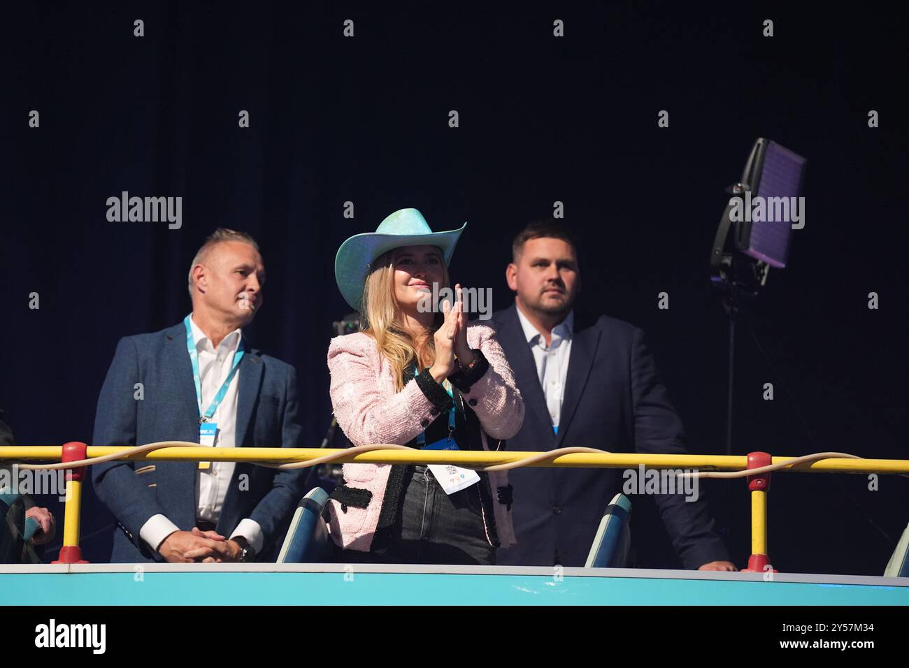 Holly Candy listens to Reform UK leader Nigel Farage speaking during ...