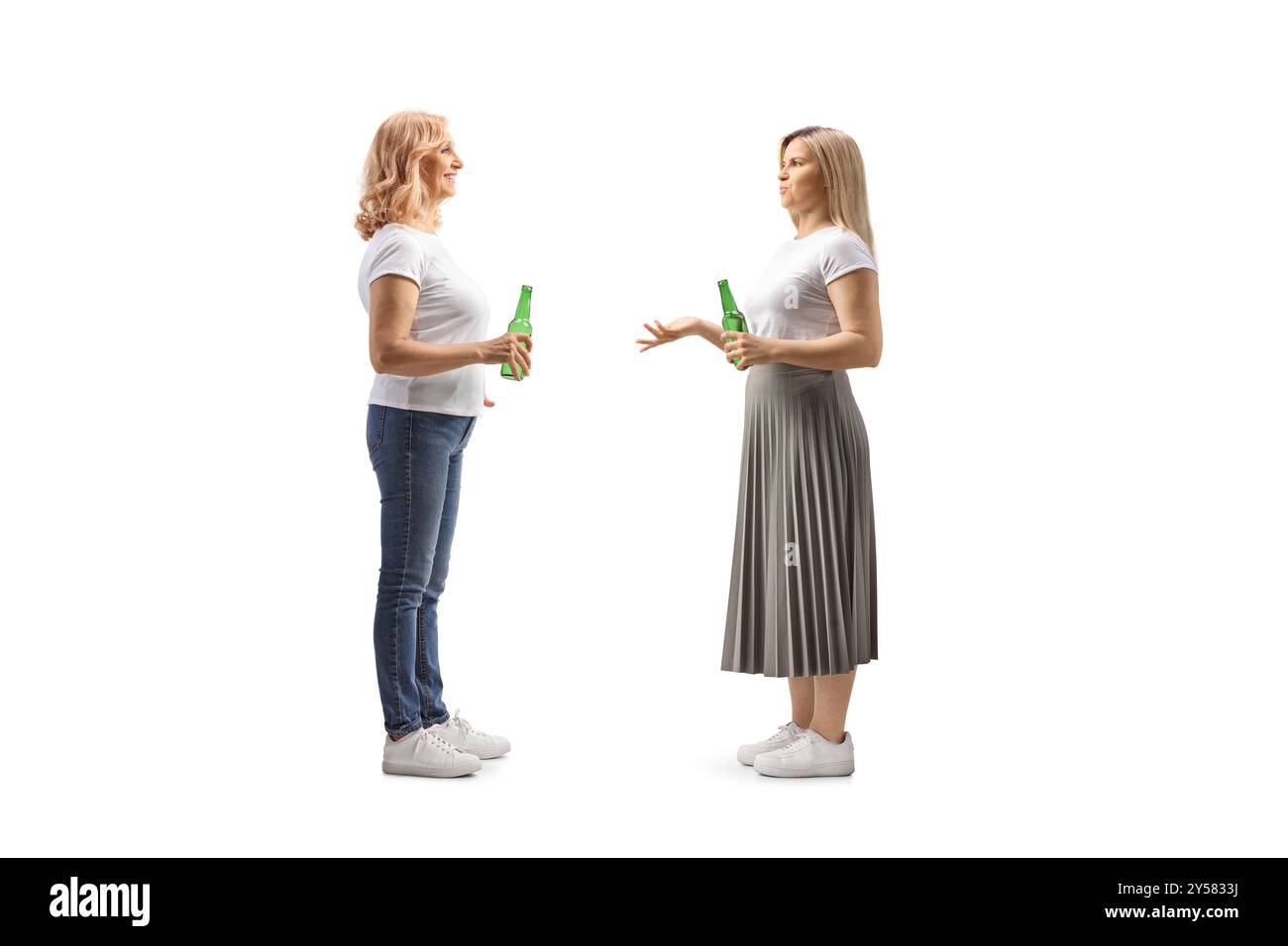 Full length profile shot of two women holding bottles of beer and ...