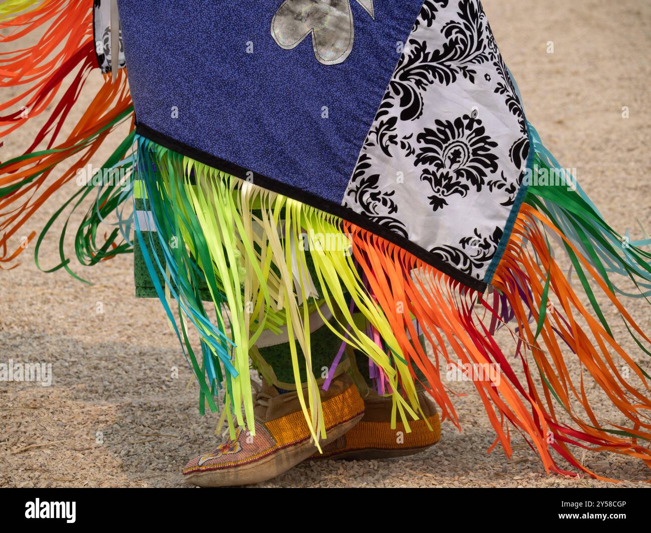 Close-up of a Native American girl wearing a ribbon shawl and beaded ...